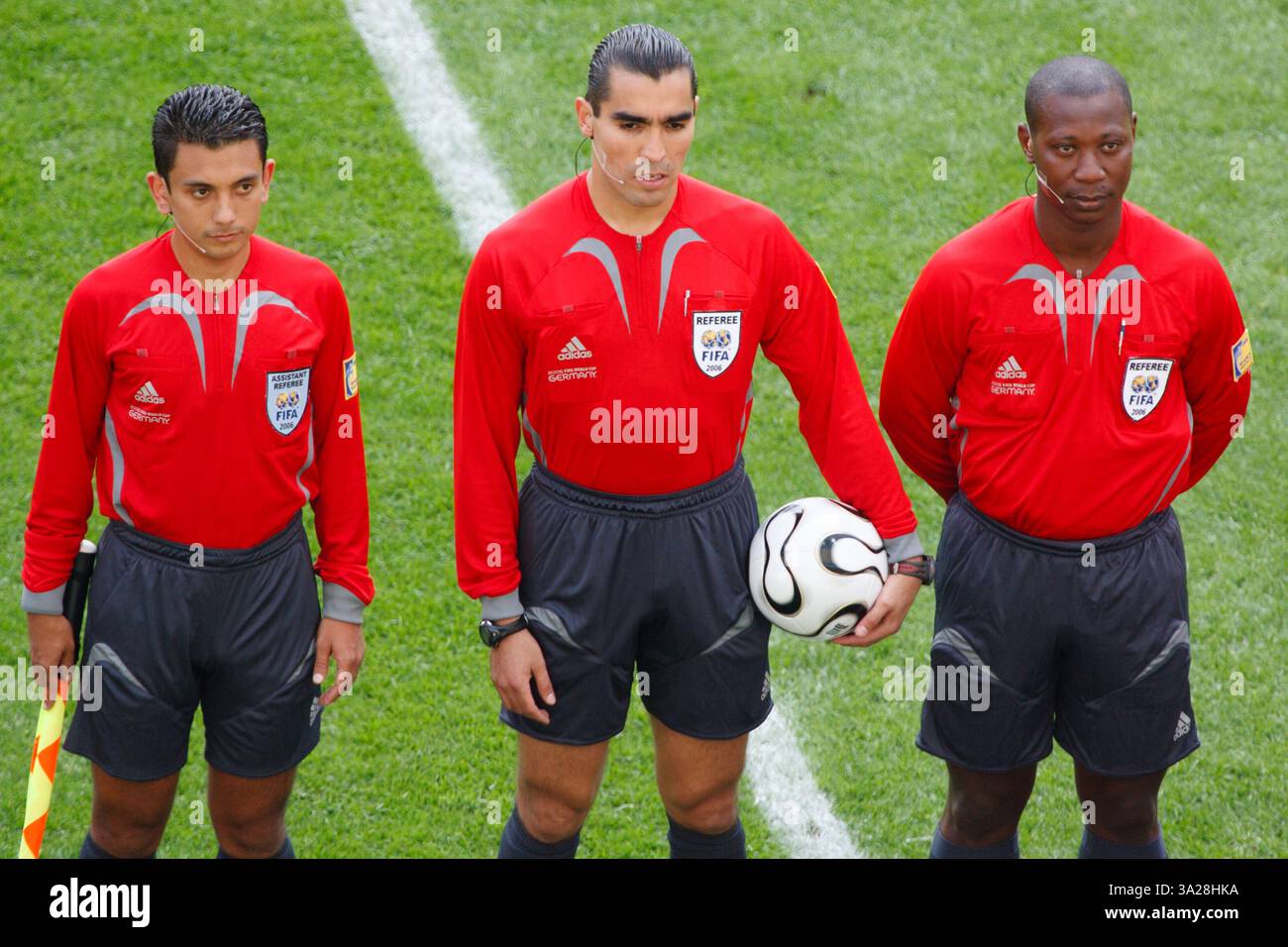 Referee Marco Rodriguez holds the match ball while standing with ...