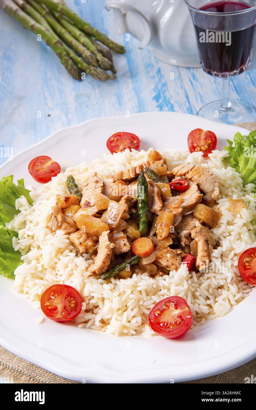 Turkey fricassee on rice with asparagus and peppers Stock Photo - Alamy