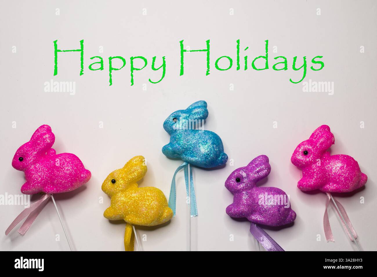 Colorful small bunny rabbits with HAPPY HOLIDAYS text isolated on ...
