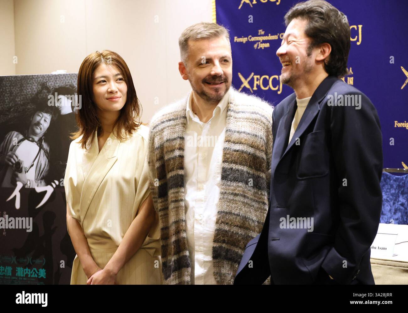 Tokyo, Japan. 12th Mar, 2025. British filmmaker Mark Gill (C) poses with Japanese actor Tadanobu ...
