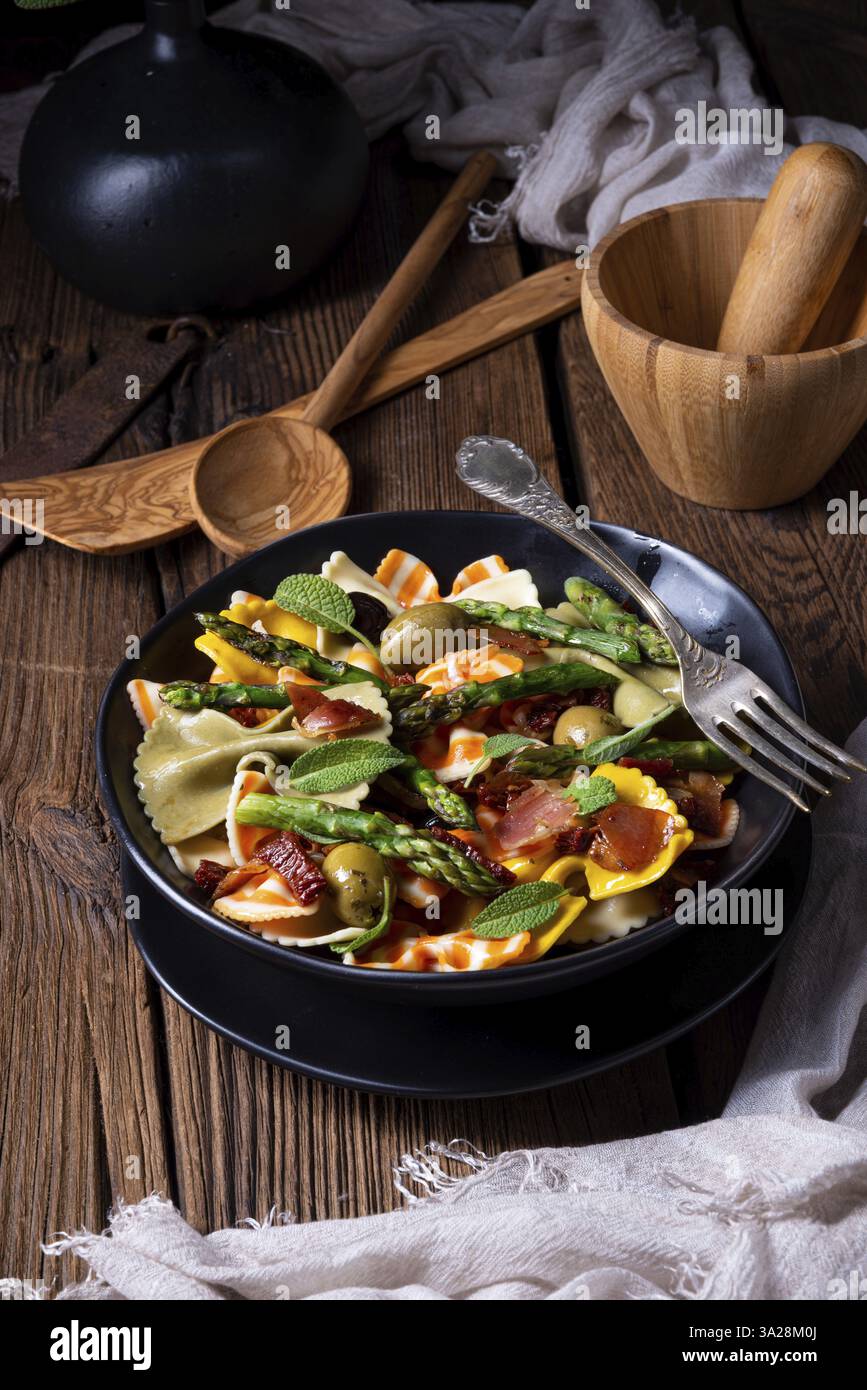 Pasta salad with green asparagus, olives and Parma ham Stock Photo - Alamy