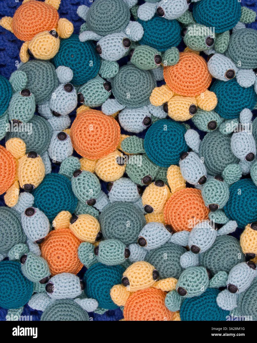 Close up above view on hand made crochet turtles in yellow and orange ...