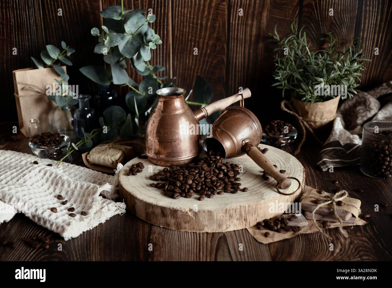 The photograph shows two copper coffee pots standing on a wooden sawn ...