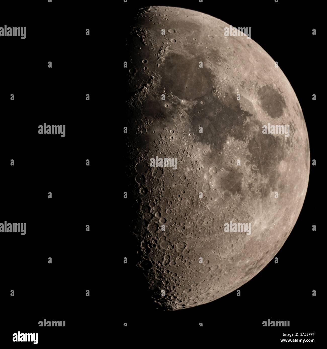 First quarter moon with detailed craters and surface textures ...