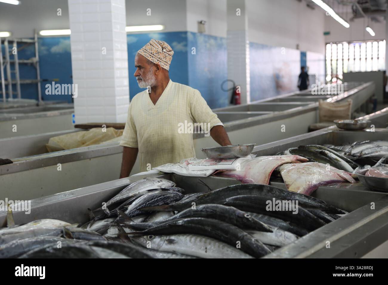 Omani man selling fish at Mutrah Fish Souk Oman Stock Photo - Alamy
