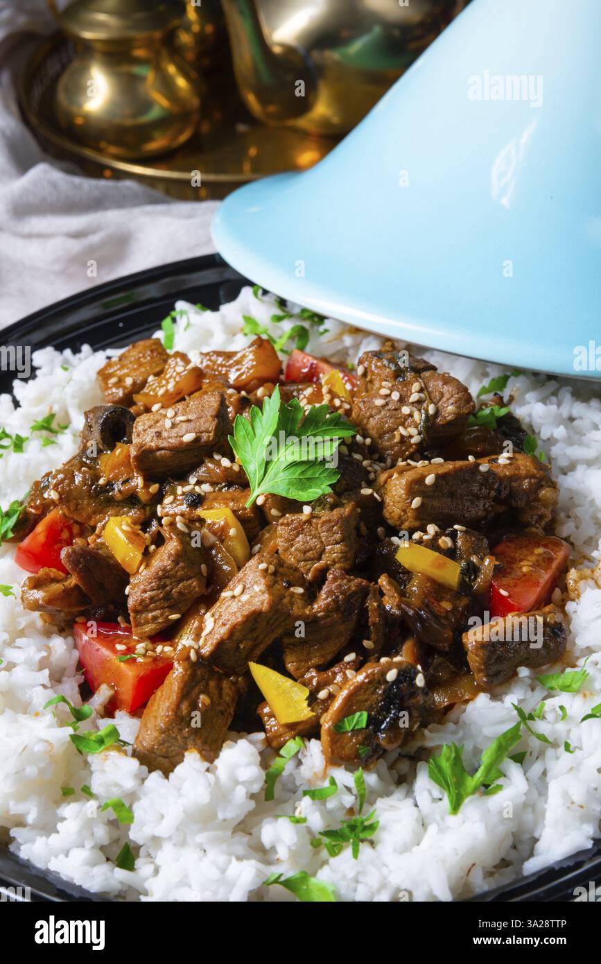 Tajin beef stew with rice, peppers and sesame seeds Stock Photo - Alamy