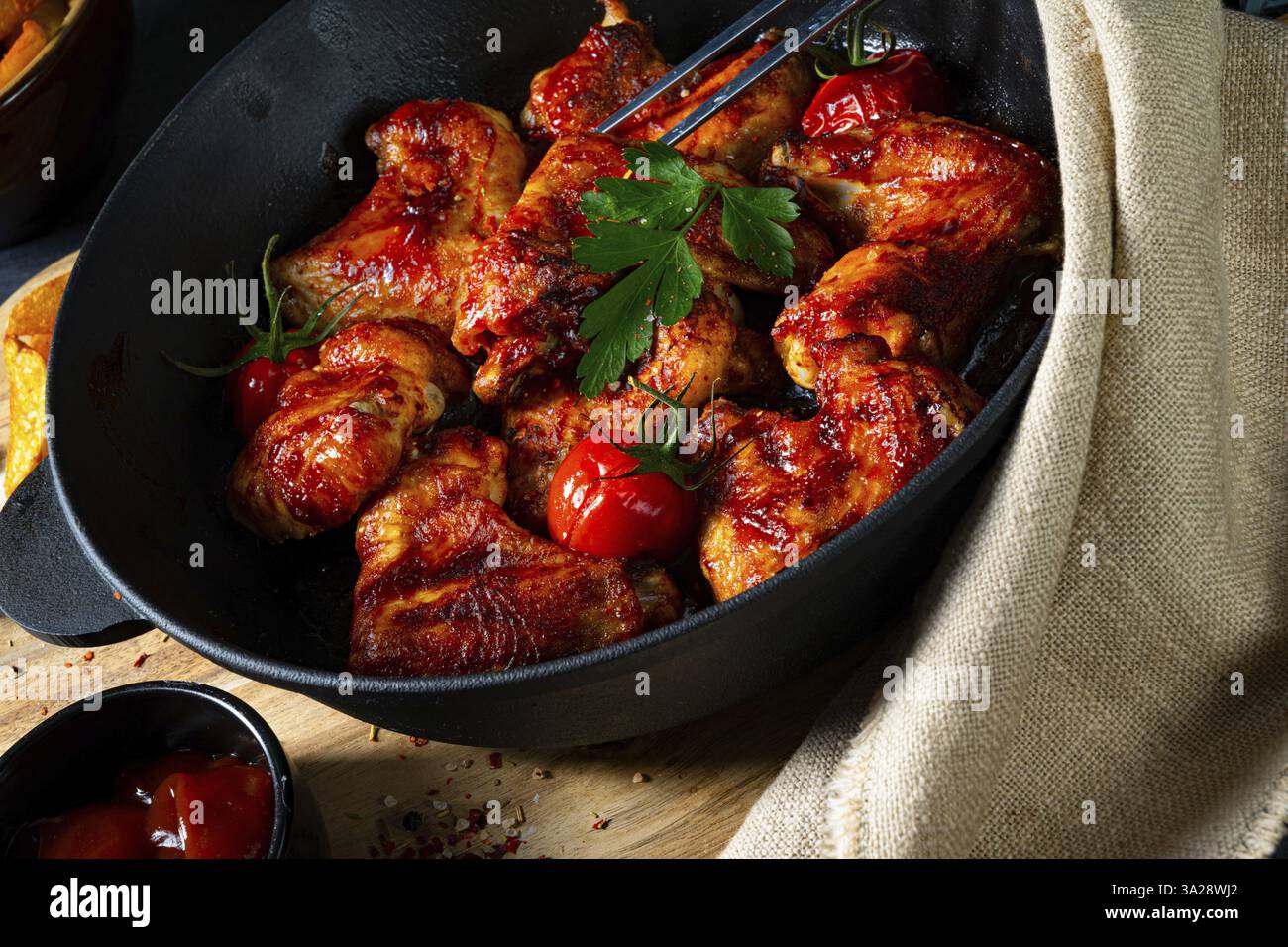 Savoury chicken wings in honey with potato wedges Stock Photo - Alamy
