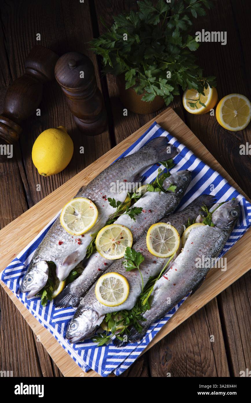 Fresh trout with lemon and various herbs Stock Photo - Alamy