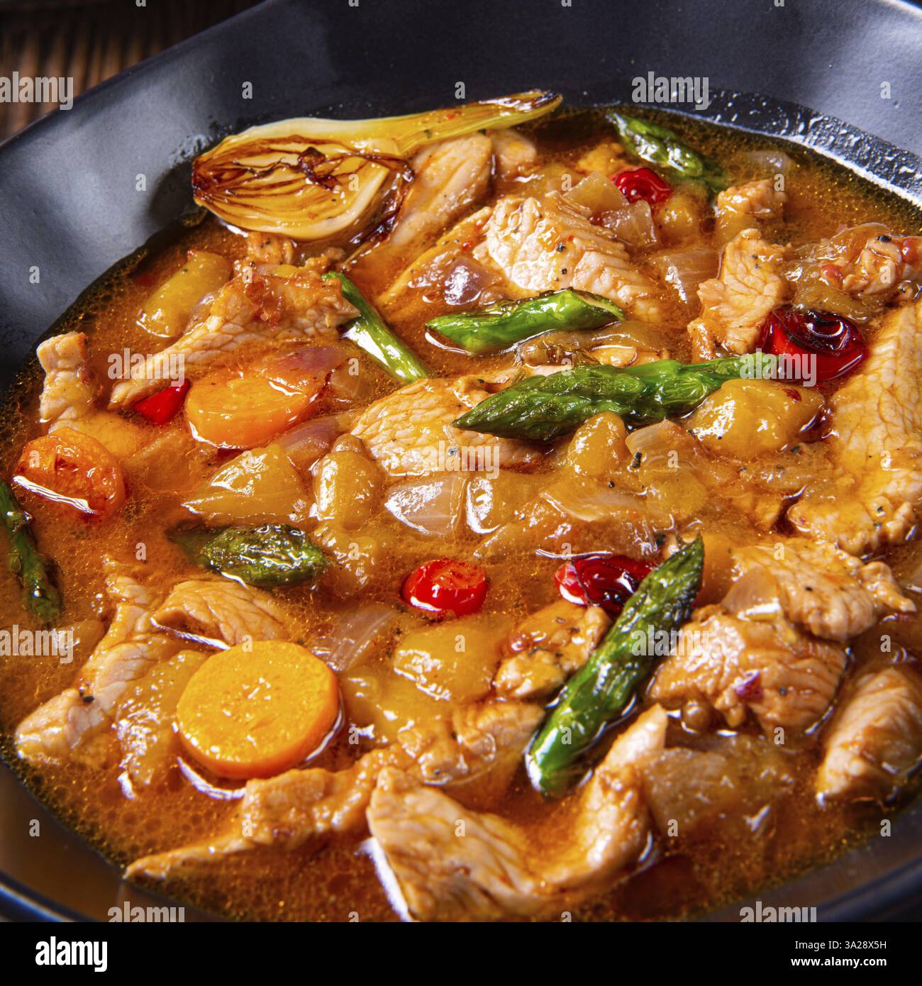 Colourful turkey fricassee with asparagus and peppers Stock Photo - Alamy