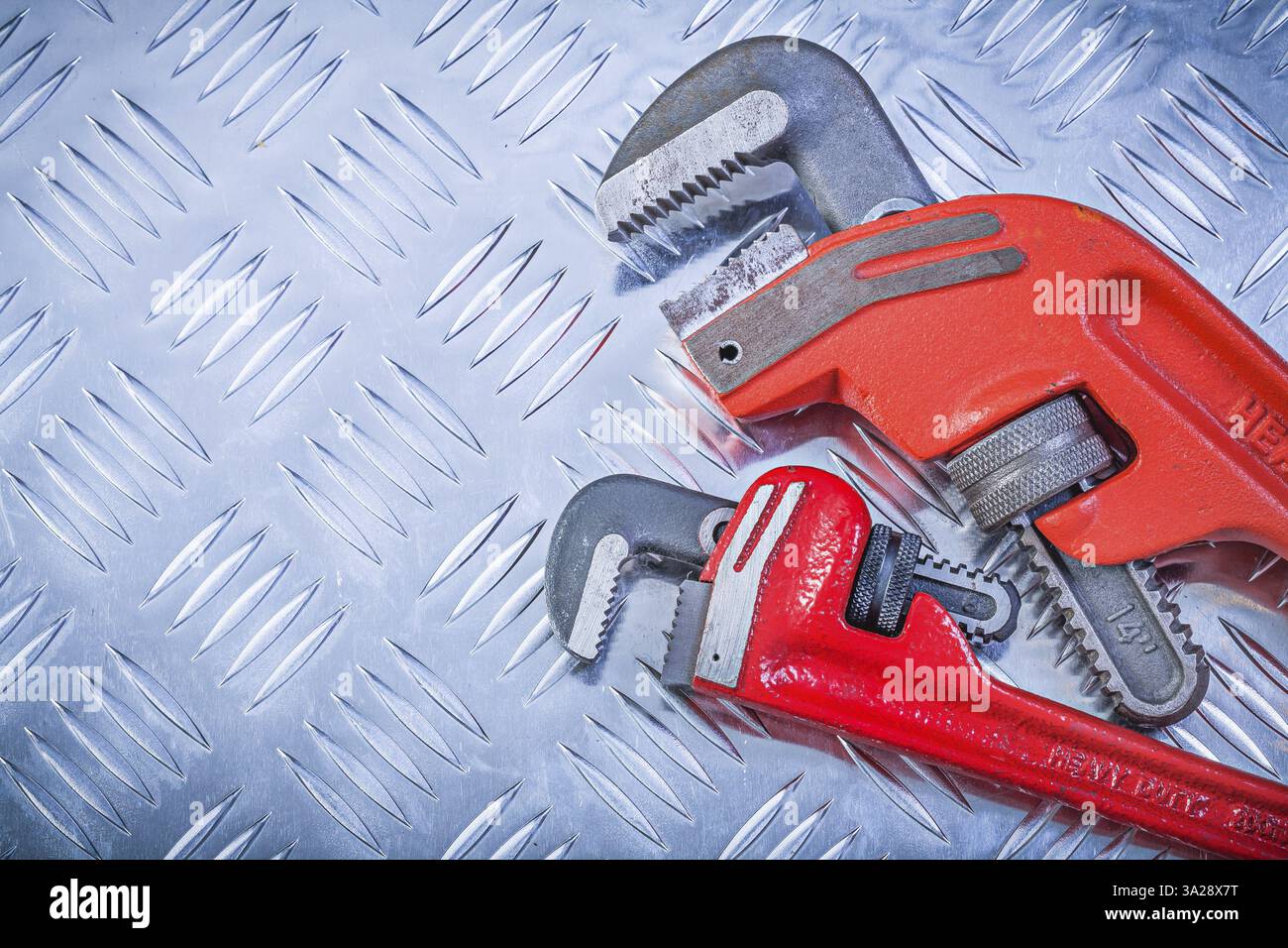 Set of pipe wrenches on fluted metal plate construction concept Stock ...