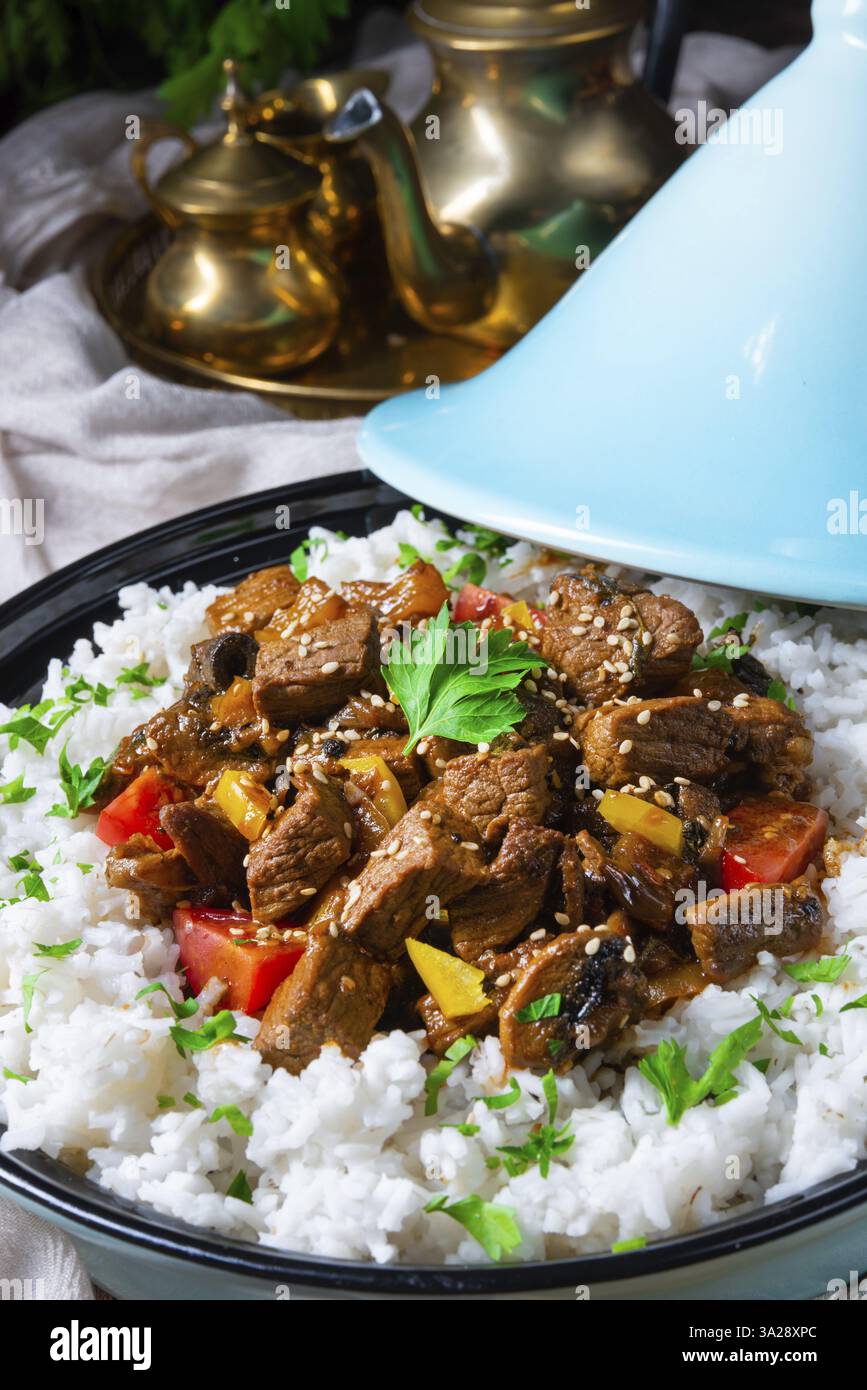 Tajin beef stew with rice, peppers and sesame seeds Stock Photo - Alamy