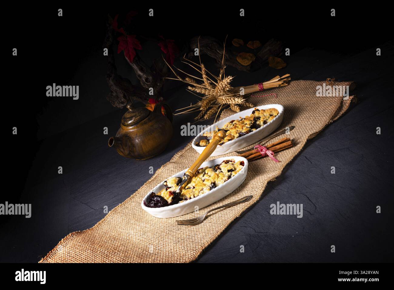 Cinnamon plums with crumble Stock Photo - Alamy