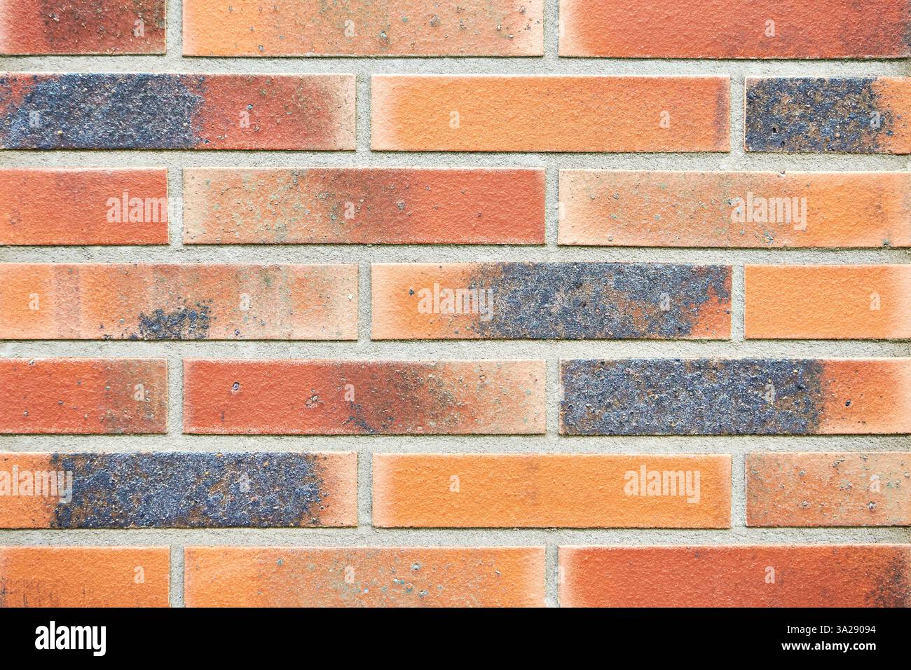 Colored red orange brick wall background Stock Photo - Alamy