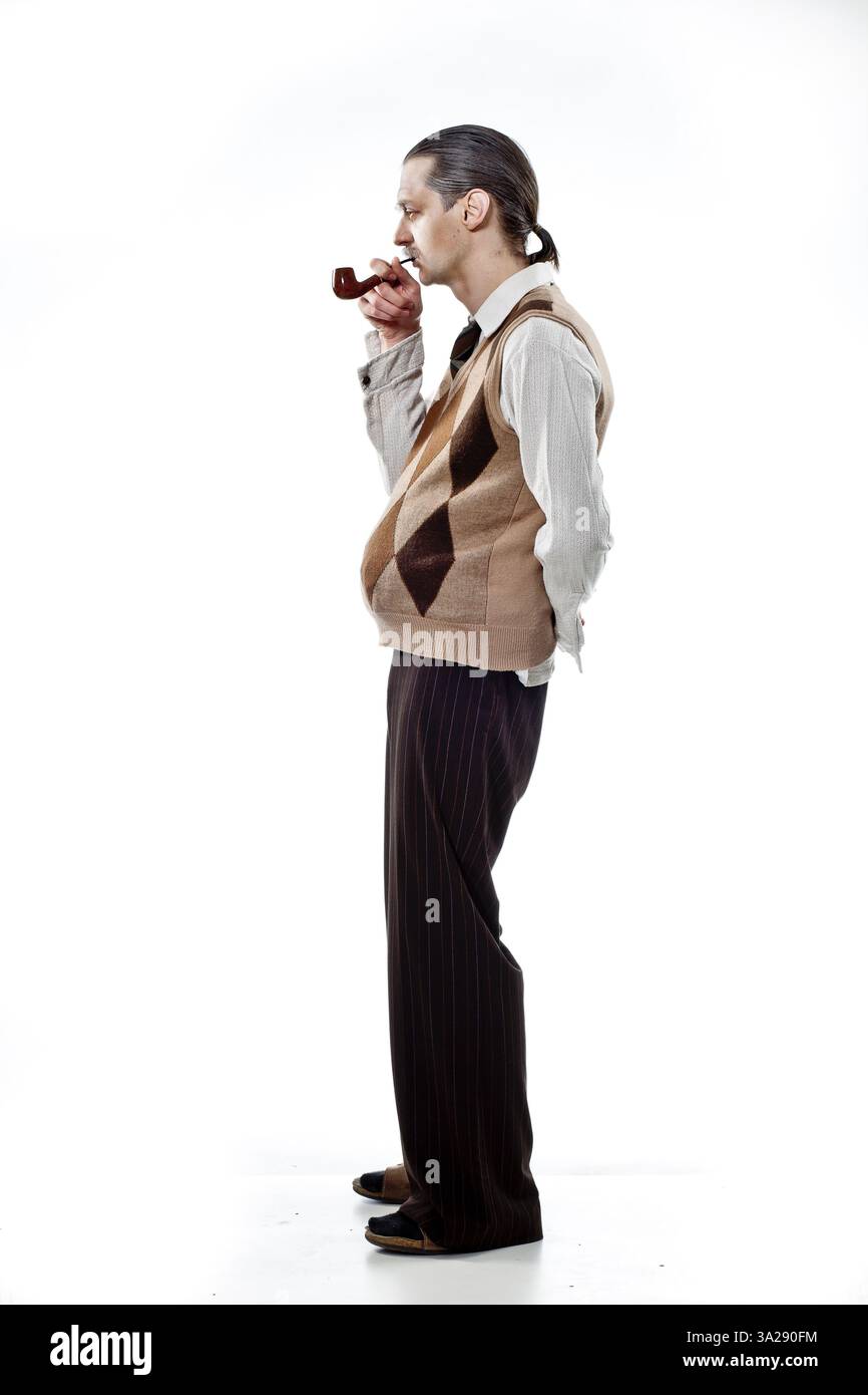 A man in vintage attire, wearing a patterned vest and striped trousers ...
