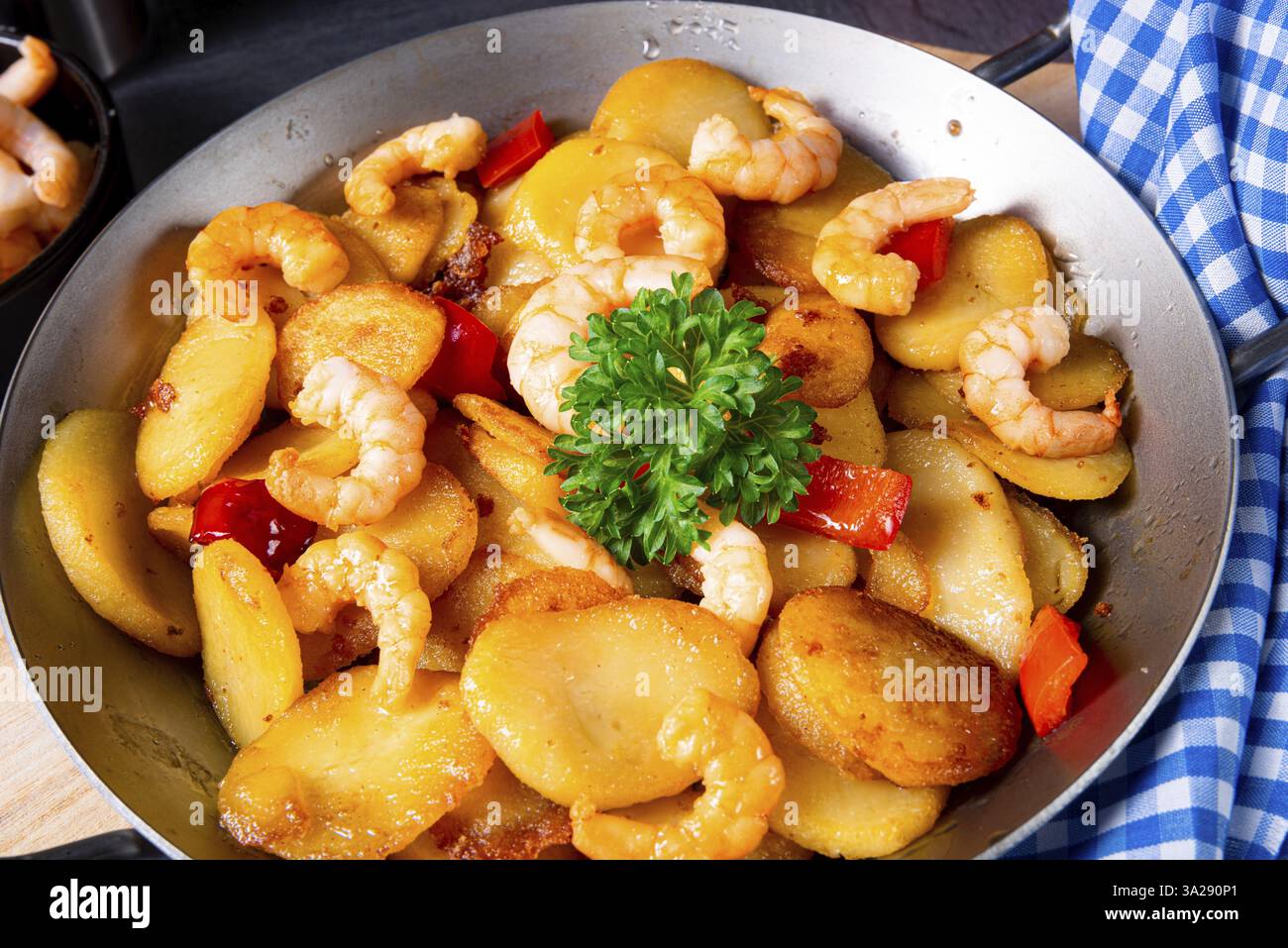 A delicious fried potato and prawn pan Stock Photo - Alamy