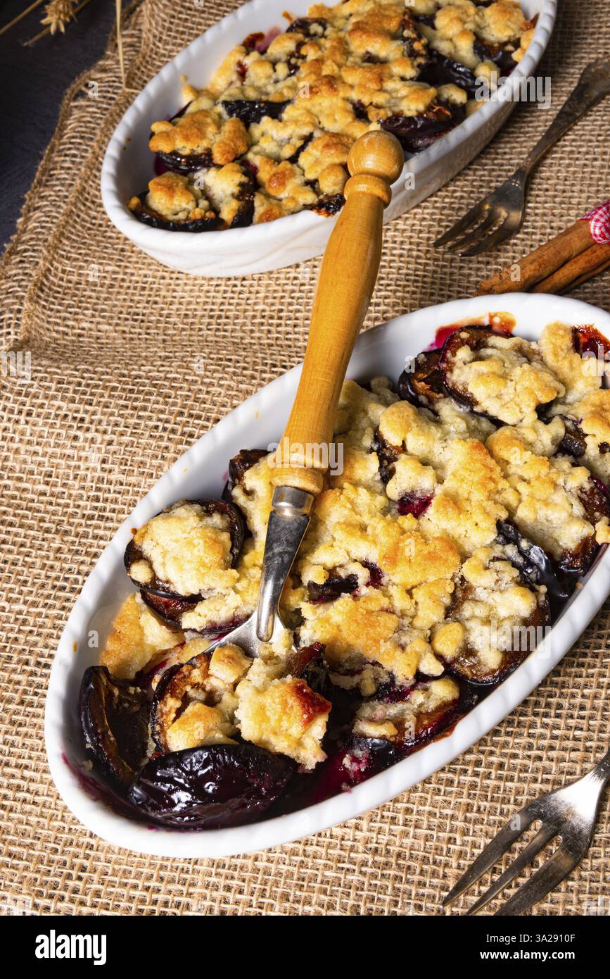 Cinnamon plums with crumble Stock Photo - Alamy