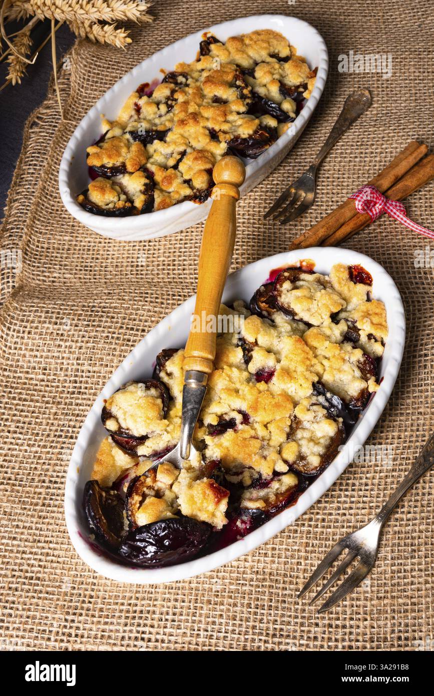Cinnamon plums with crumble Stock Photo - Alamy