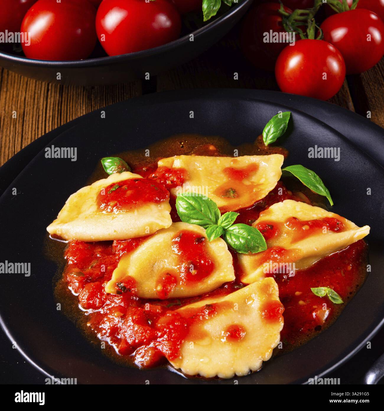 Ravioli alla genovese with basil and tomato sauce Stock Photo - Alamy