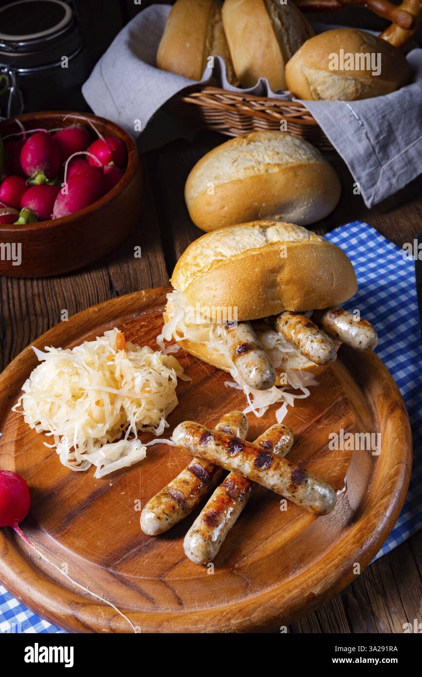 Rustic Nuremberg bratwurst with sauerkraut and bread roll Stock Photo ...
