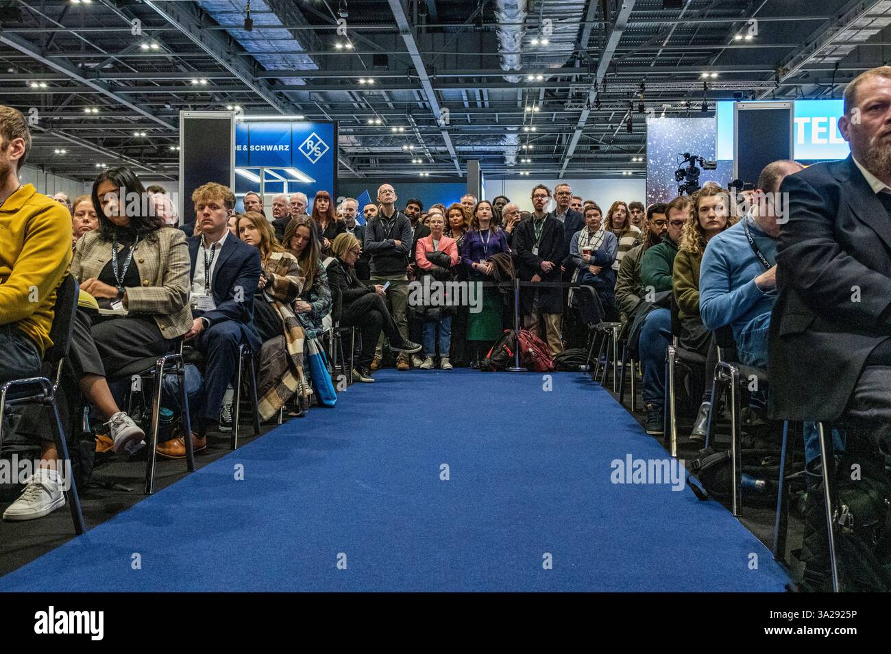 An audience of space industry professionals watching a presentation at ...