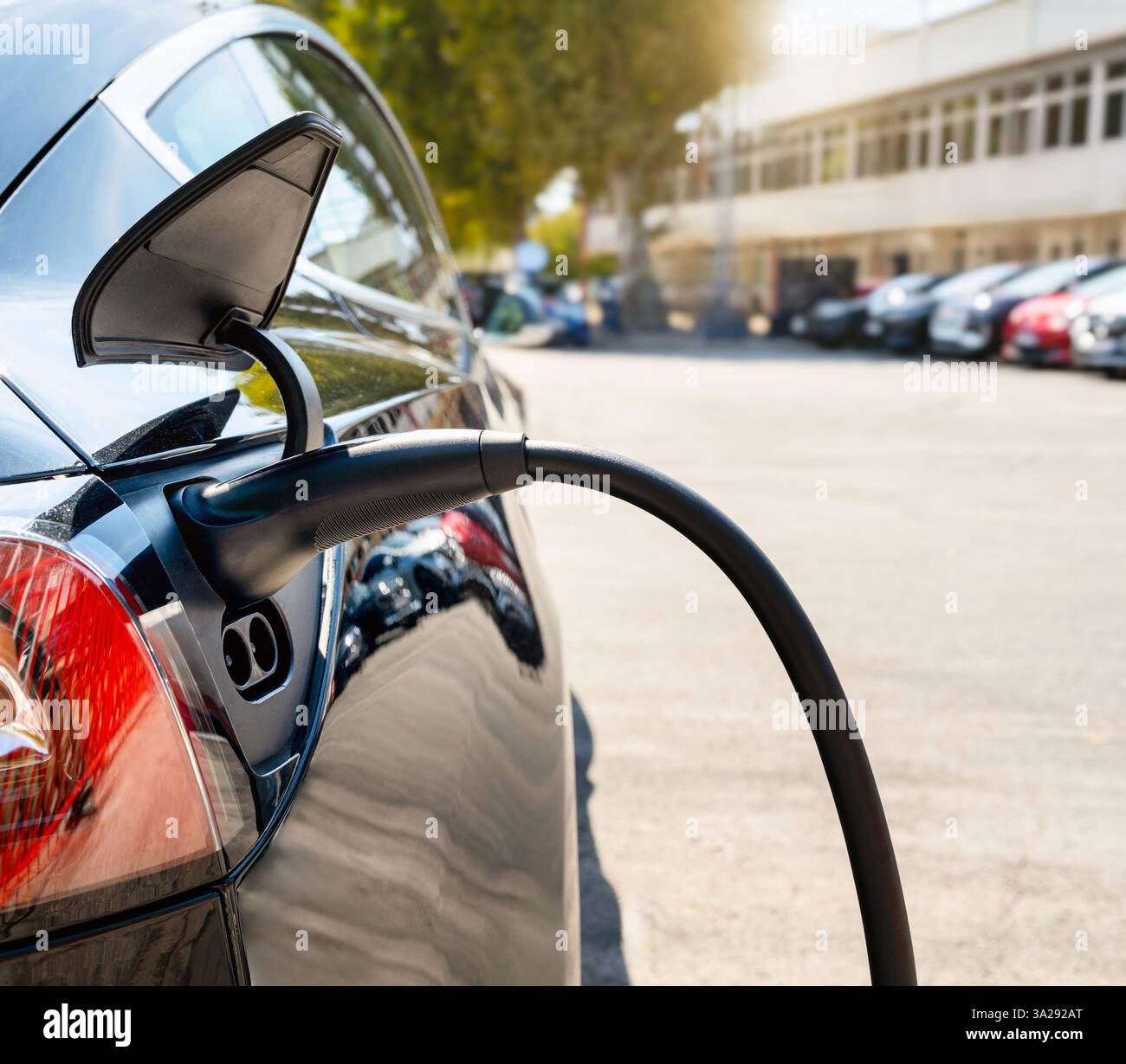 Close-up of EV charging plug inserted into electric car at charging ...