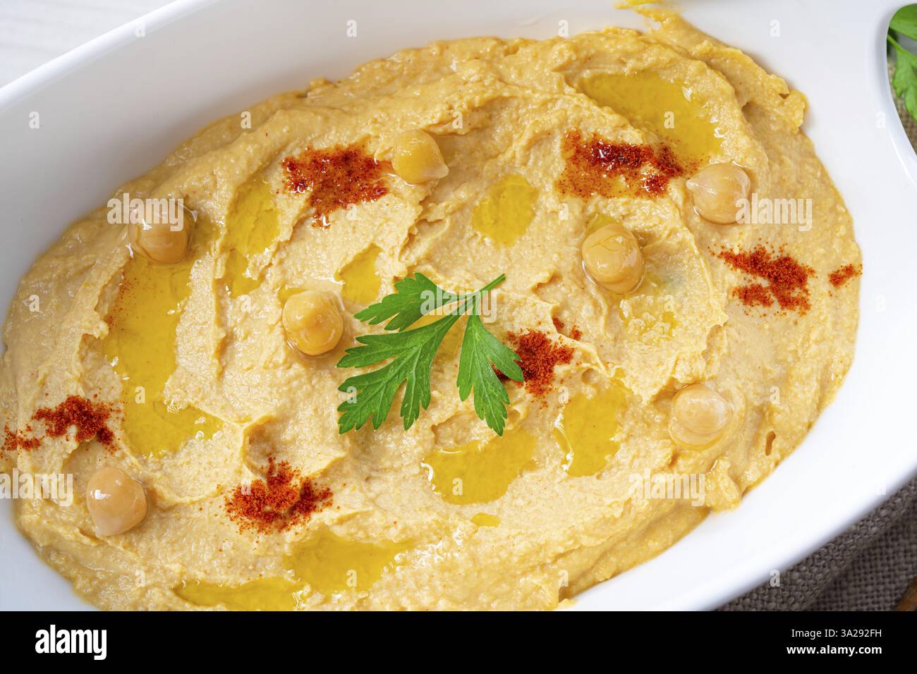 Hummus paste with lemon and chilli on a white background Stock Photo ...
