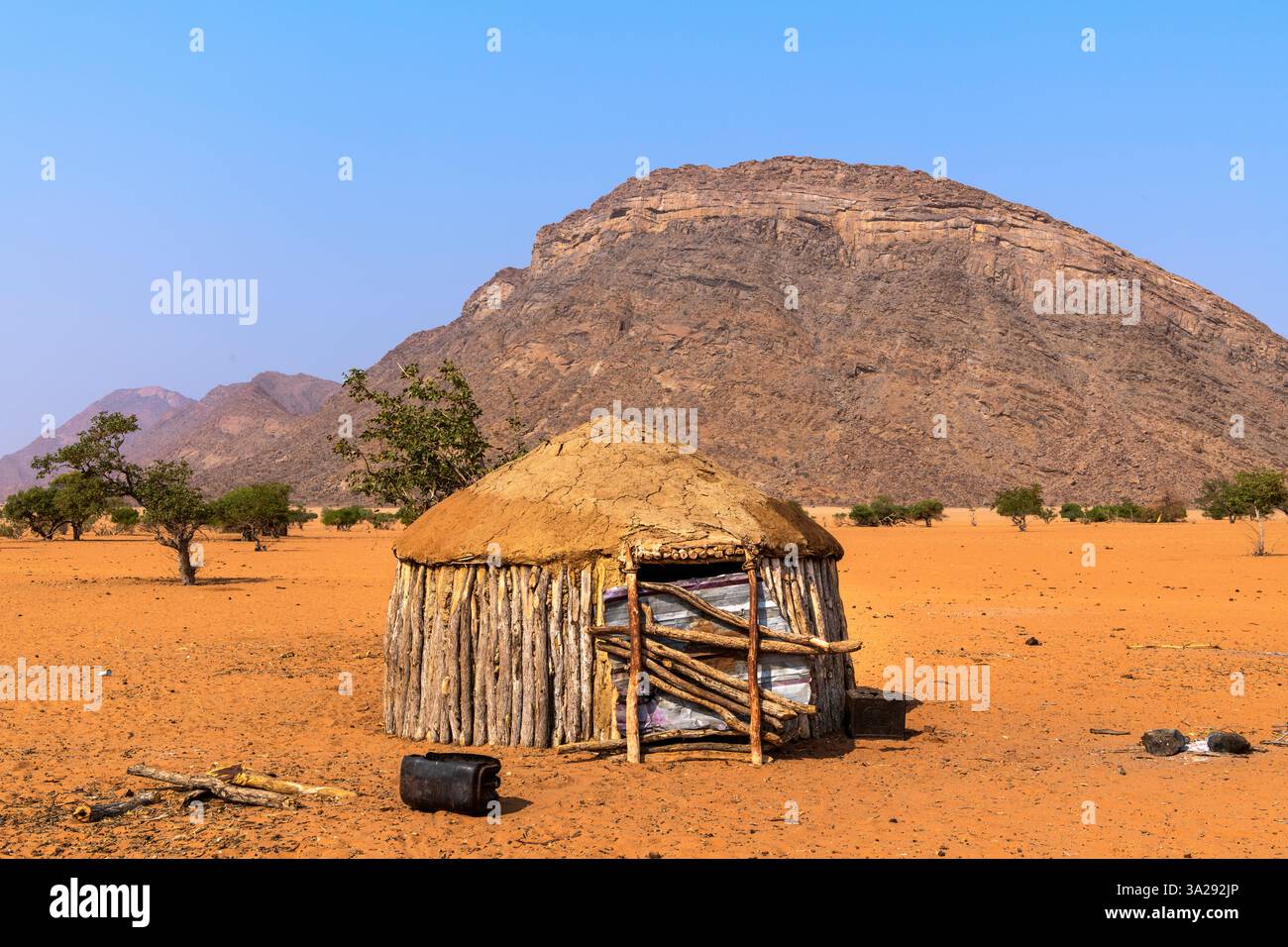 ORUPEMBE, NAMIBIA - AUGUST 8, 2024: Traditional Himba Hut in front of ...