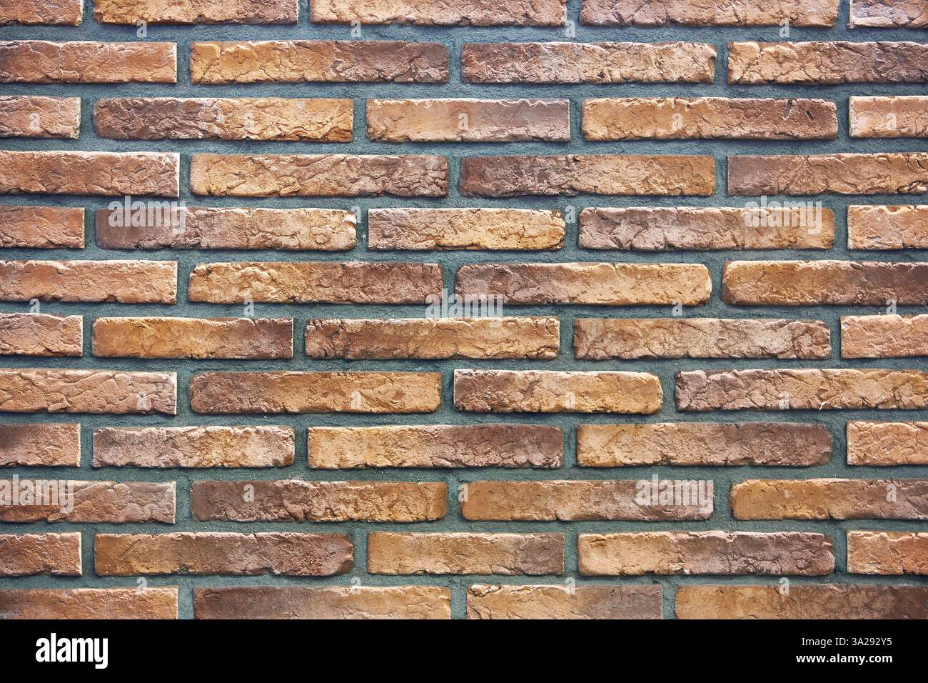 Colored red orange brick wall background Stock Photo - Alamy