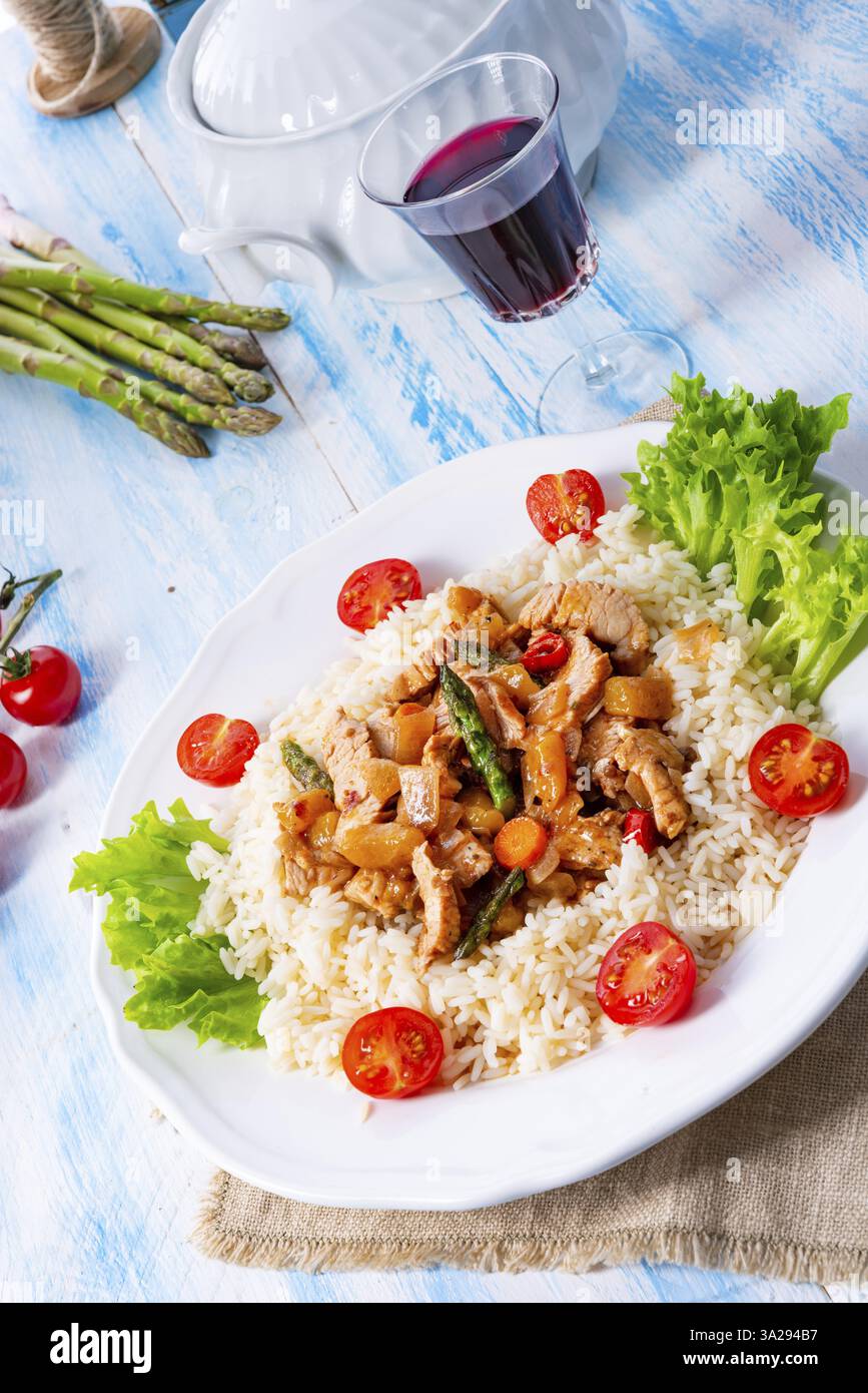 Turkey fricassee on rice with asparagus and peppers Stock Photo - Alamy