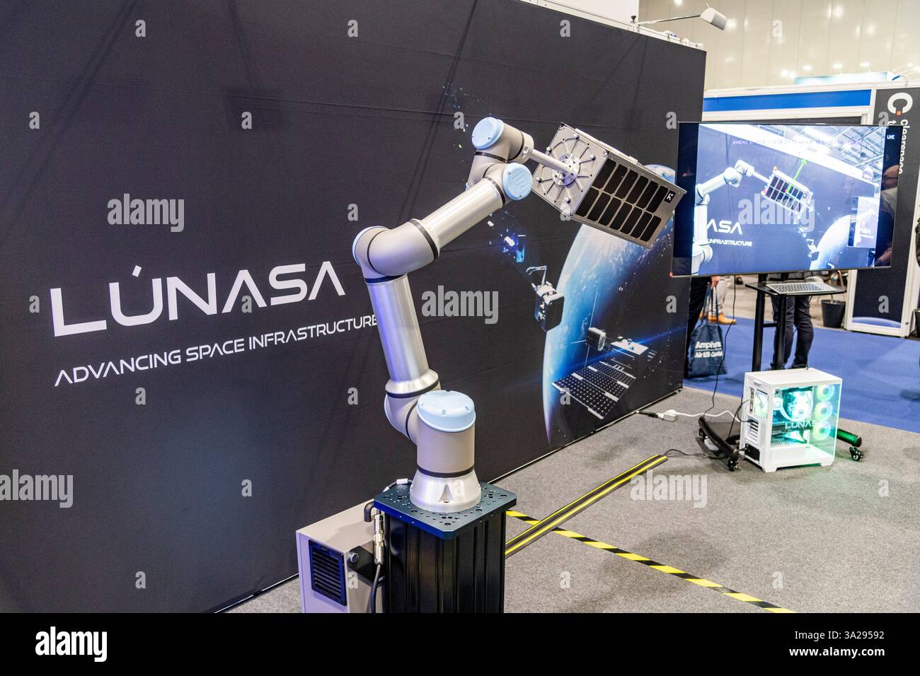 A robotic arm device being displayed by Lunasa at the Space Comm Expo ...
