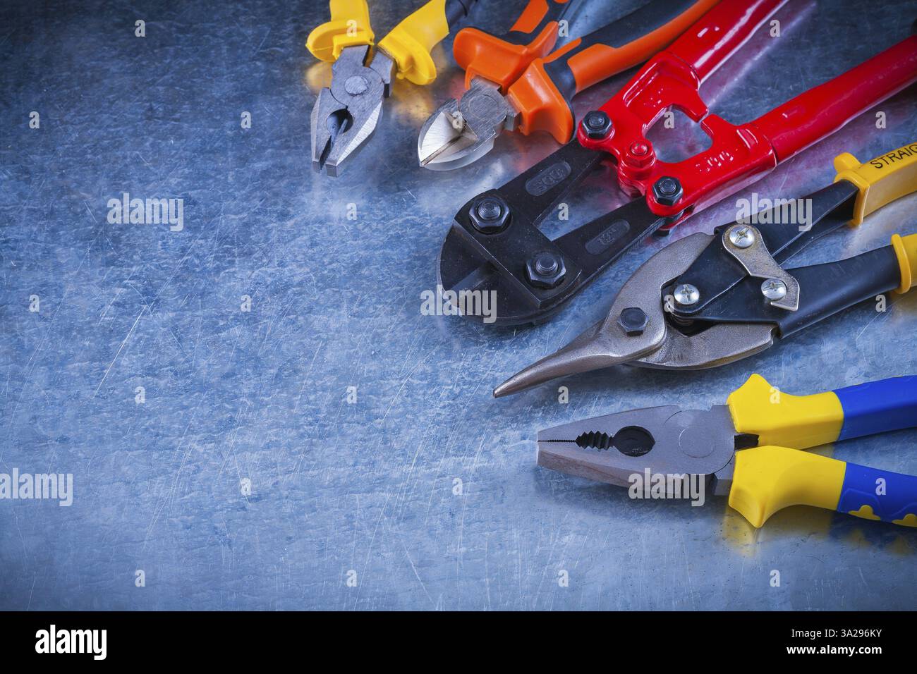 Set of bolt cutter tin snips cutting pliers gripping tongs on scratched ...