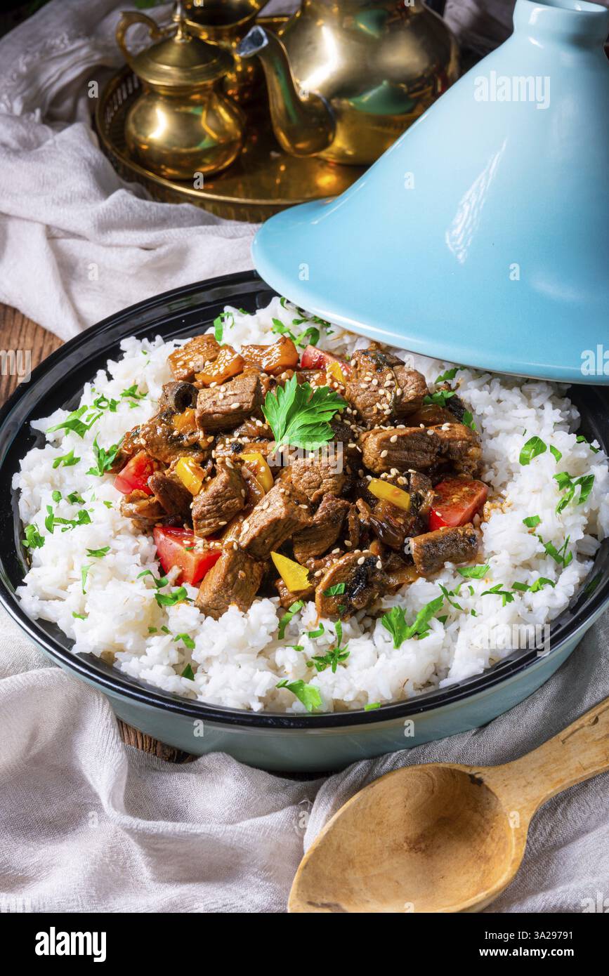 Tajin beef stew with rice, peppers and sesame seeds Stock Photo - Alamy
