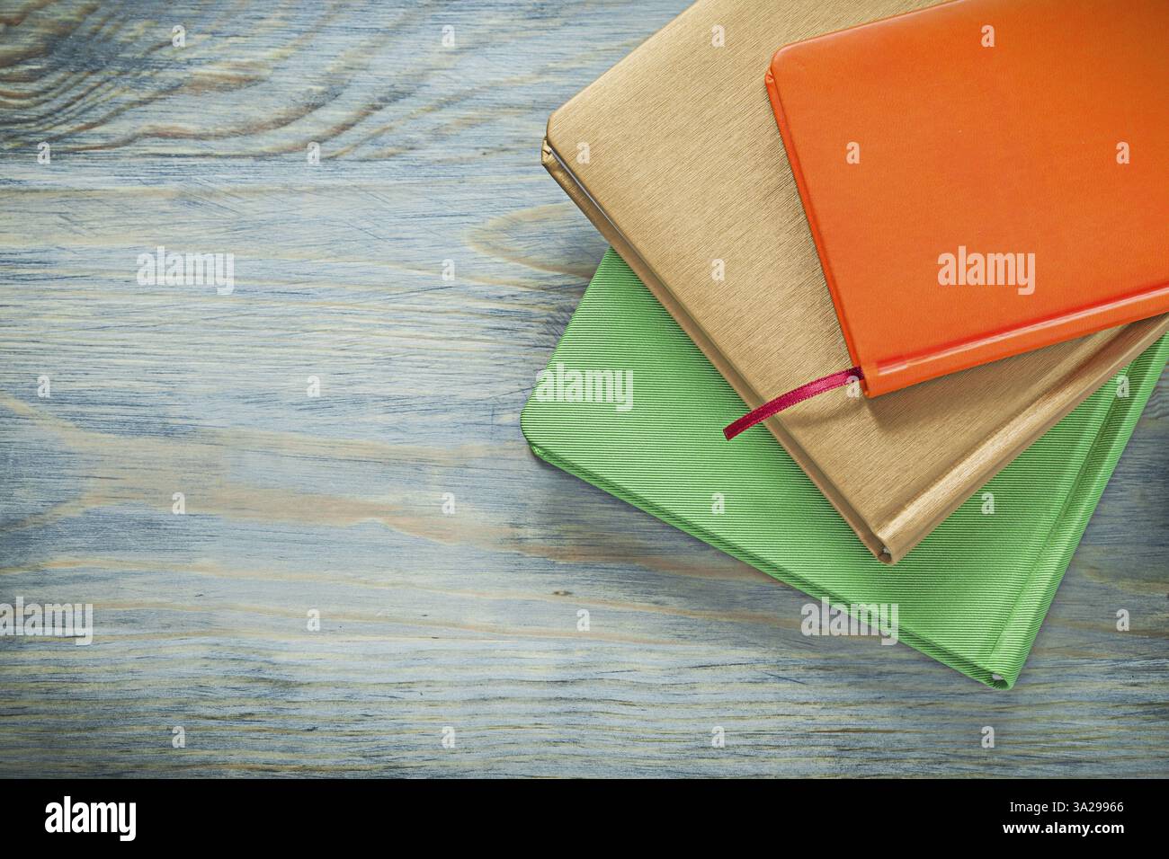 Set of notepads on wooden board education concept Stock Photo - Alamy