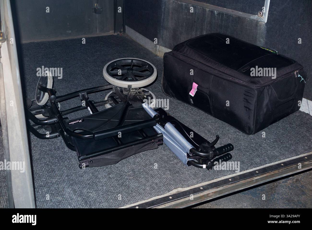 Passenger wheelchair / wheel chair, folded, stowed in cargo hold with a ...