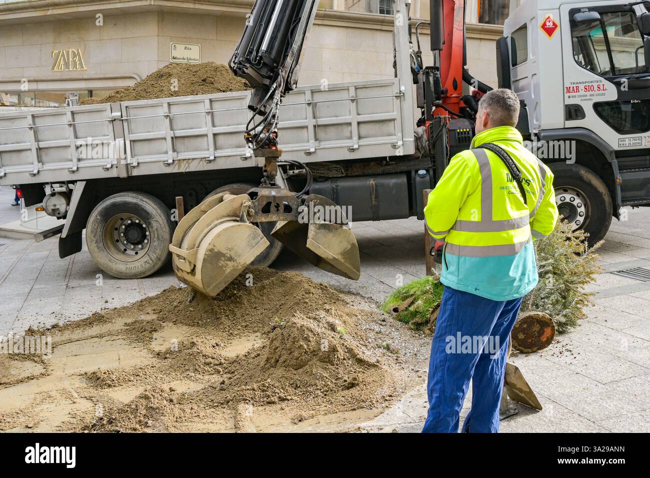 Vigo, Spain - 14 January 2025: Driver of a tipper truck with a remote ...