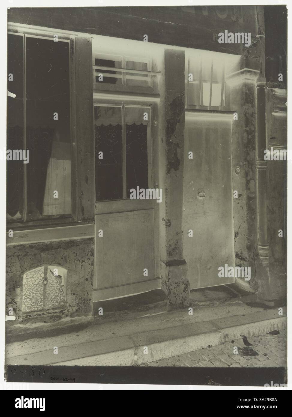 This untitled photograph by Eugène Atget features the narrow, quiet ...