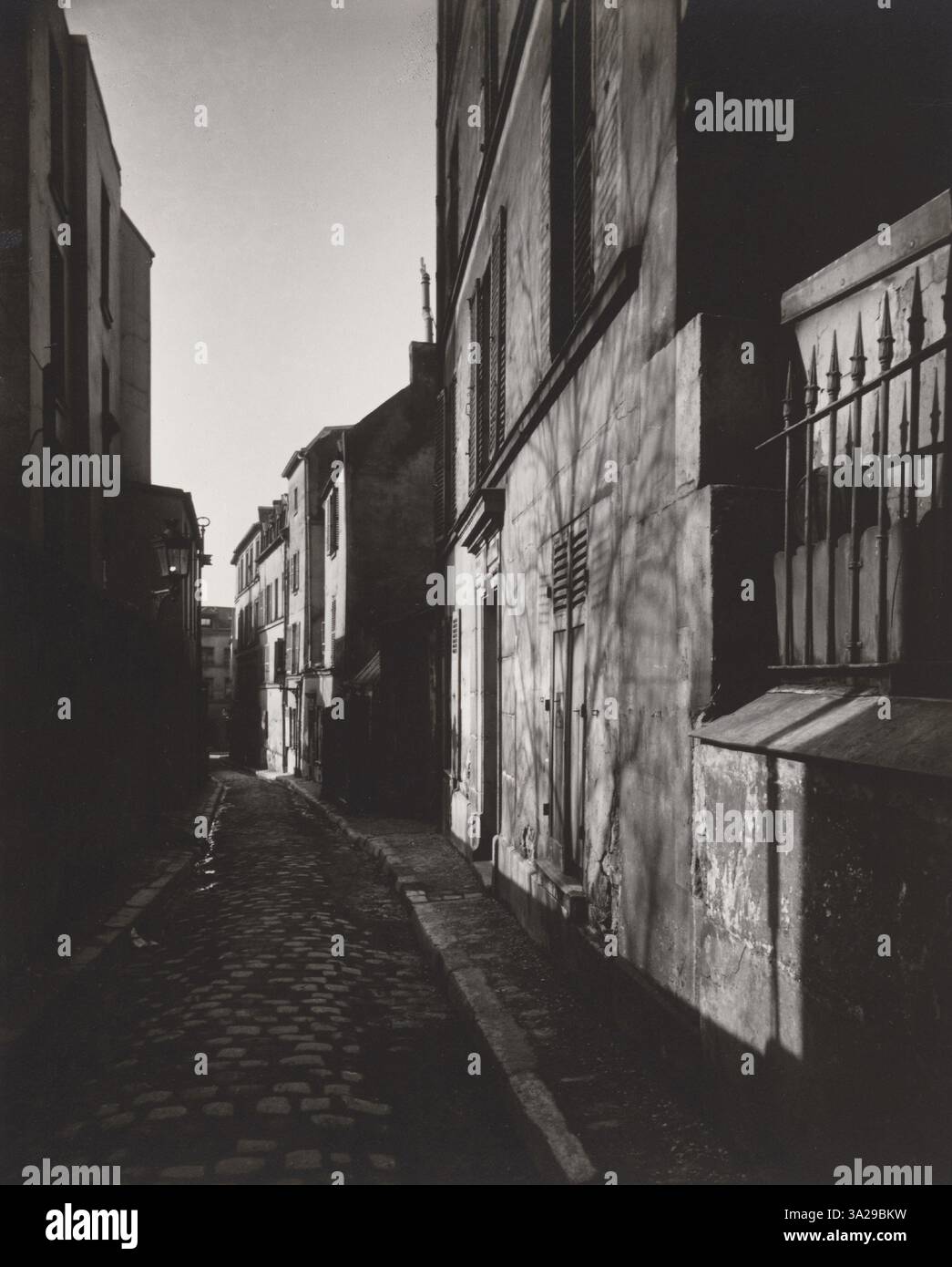This photograph by Eugène Atget shows Rue St. Rustique, a narrow street ...