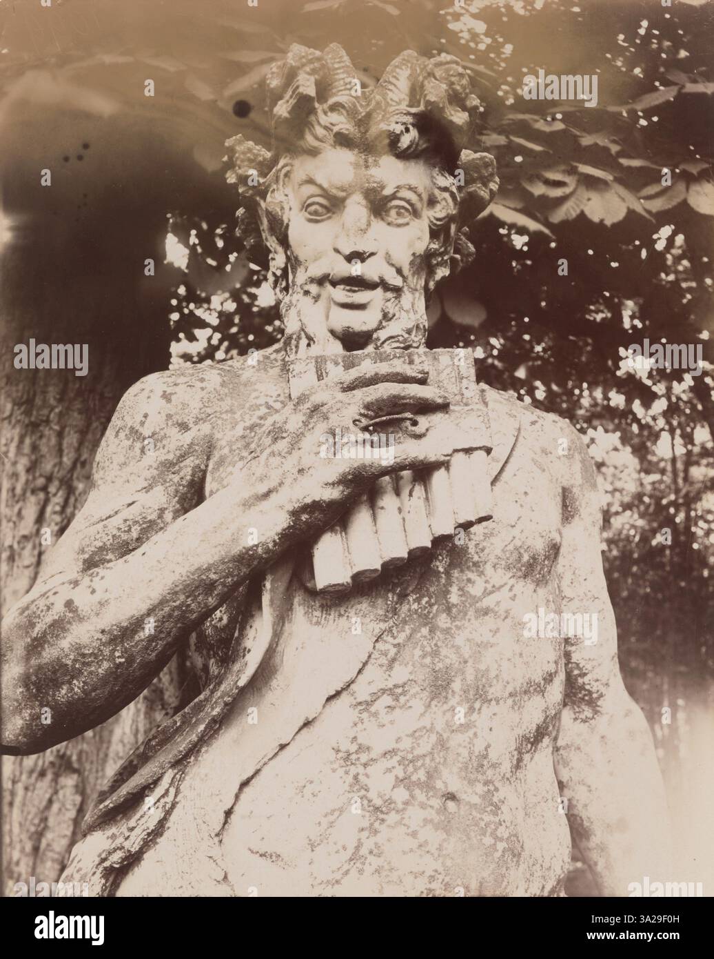 This image depicts a statue of a faun, located in the Versailles ...