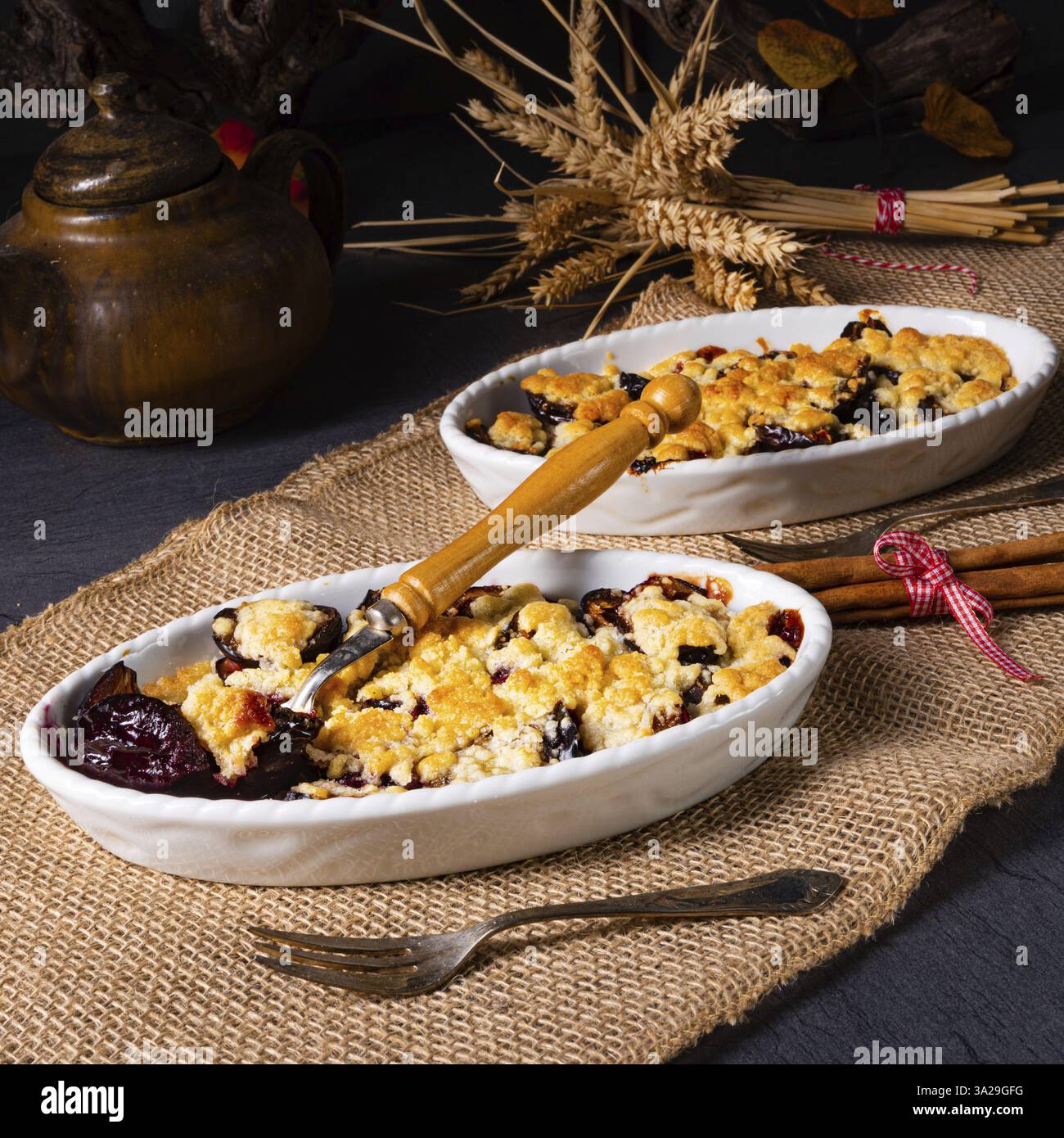 Cinnamon plums with crumble Stock Photo - Alamy