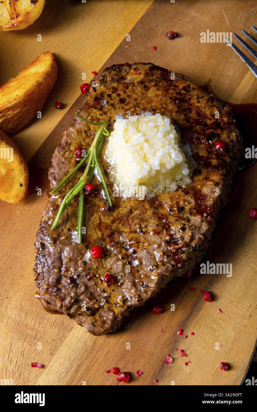 Butter beef steak with herbs and potato wedges Stock Photo - Alamy
