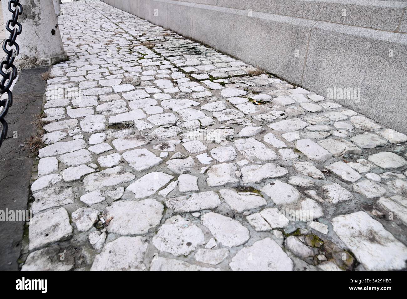 The image shows a paved path made of white uneven stones Stock Photo ...