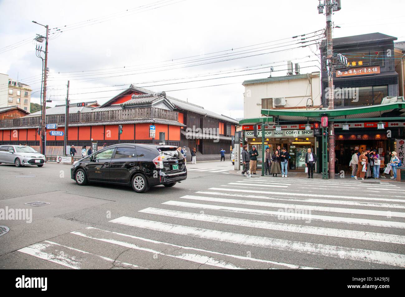 Shijo-dori street in Gionmachi, Kyoto, Japan with cars and people ...