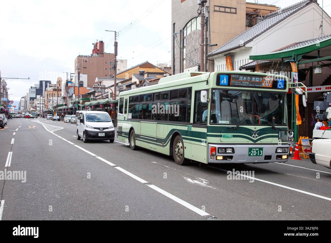 Shijo-dori street in Gionmachi, Kyoto, Japan with cars and a bus on the ...