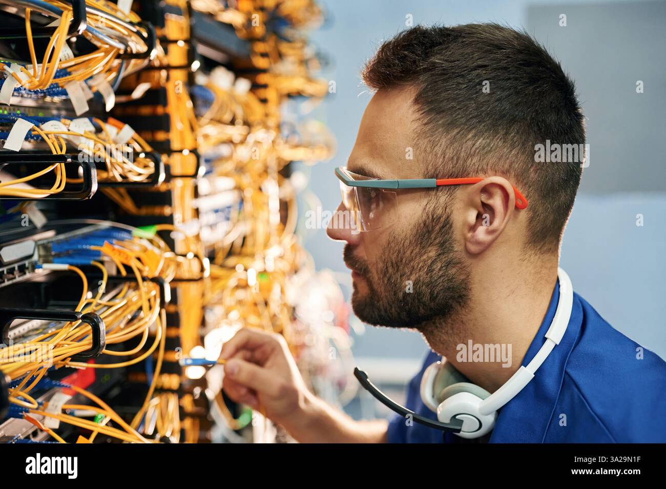 Modern technology routing. Young man is working with internet equipment ...