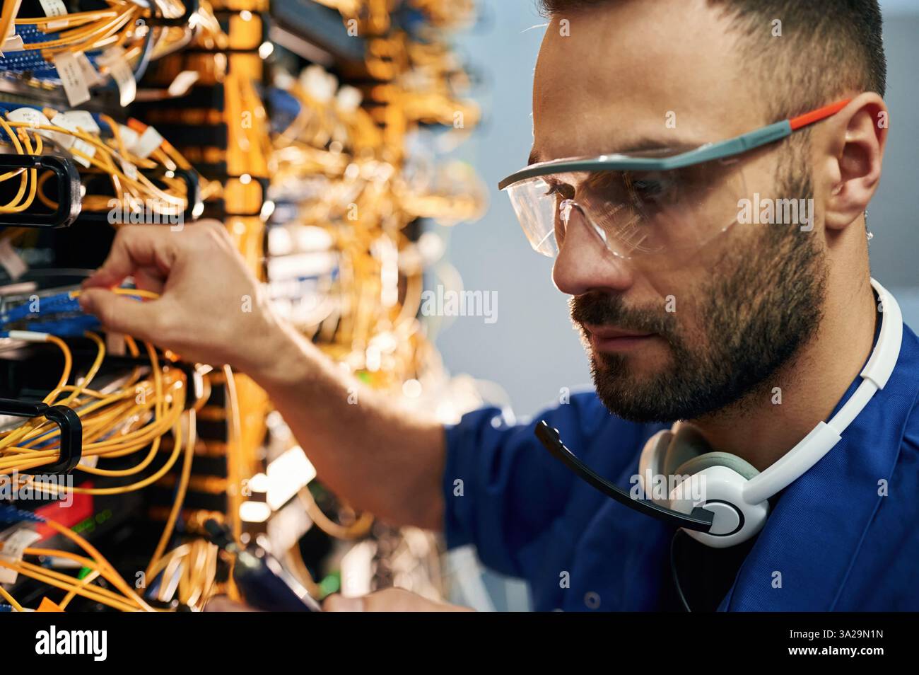 Modern technology routing. Young man is working with internet equipment ...