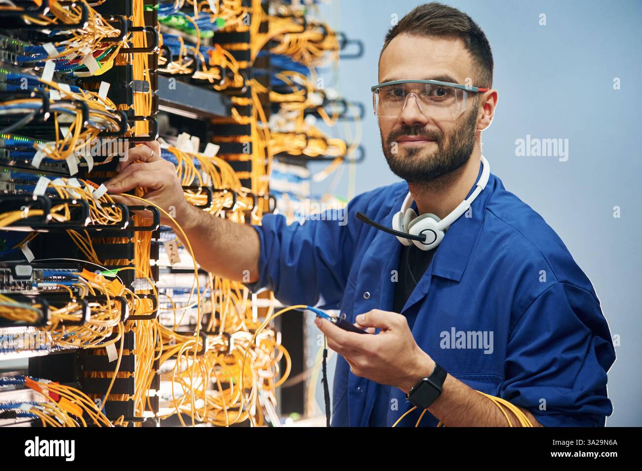 Checking signal by device. Young man is working with internet equipment ...