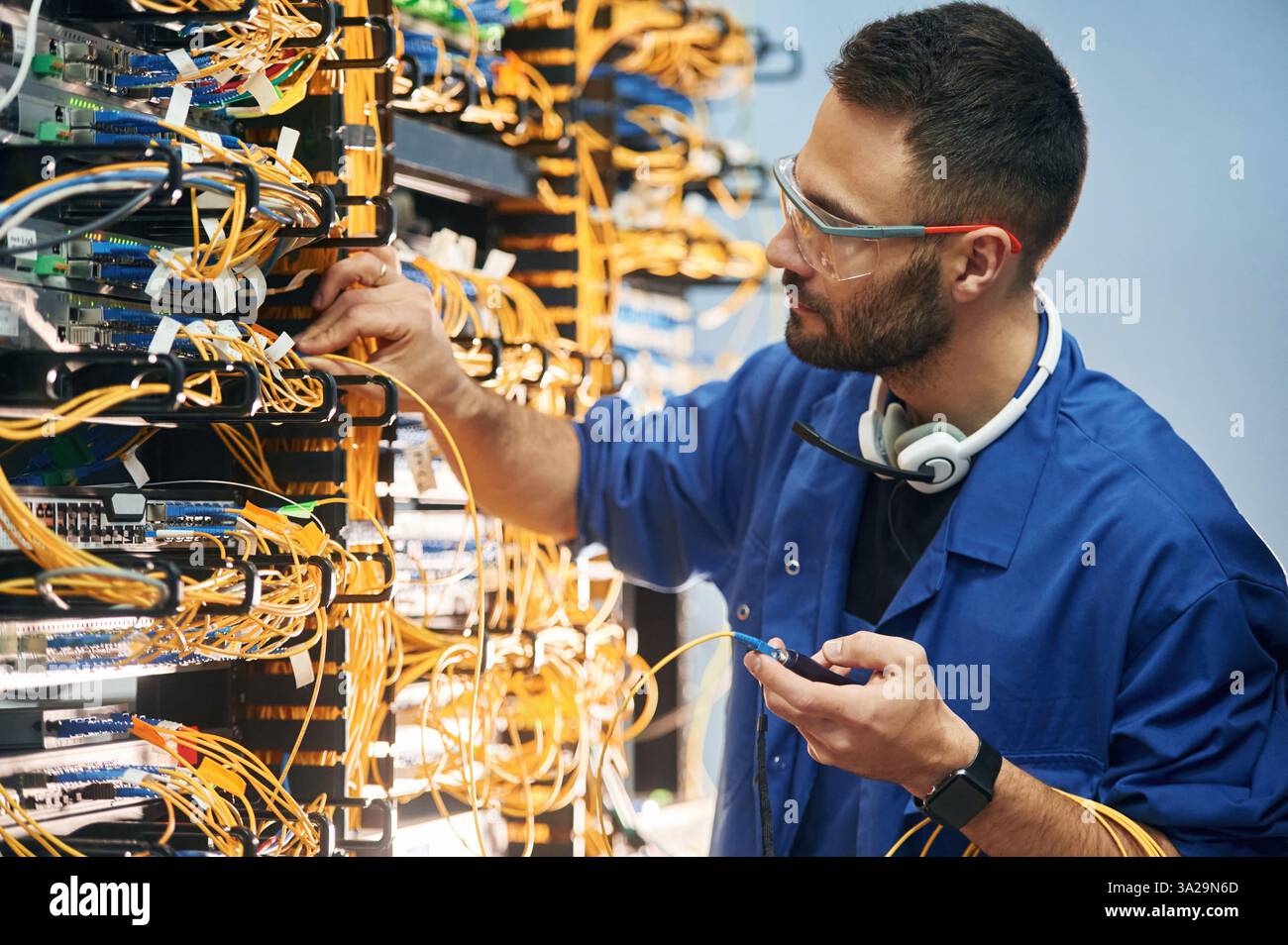 Checking signal by device. Young man is working with internet equipment ...