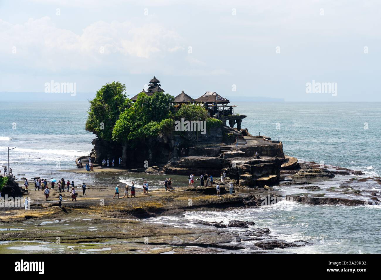 Bali, Indonesia - January 6, 2025: People visiting Tanah Lot Temple in ...