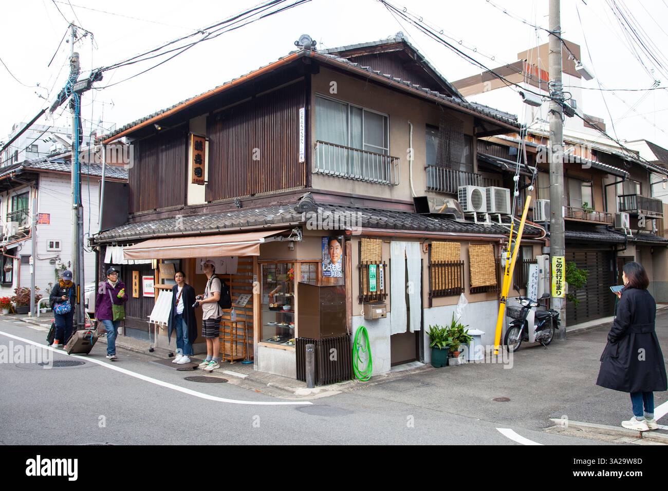 Traditional old wooden buildings and houses and people in Gionmachi ...