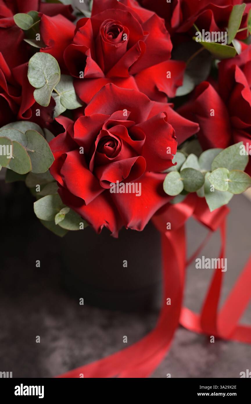 Bouquet of red roses with eucalyptus on side in black box and red ...
